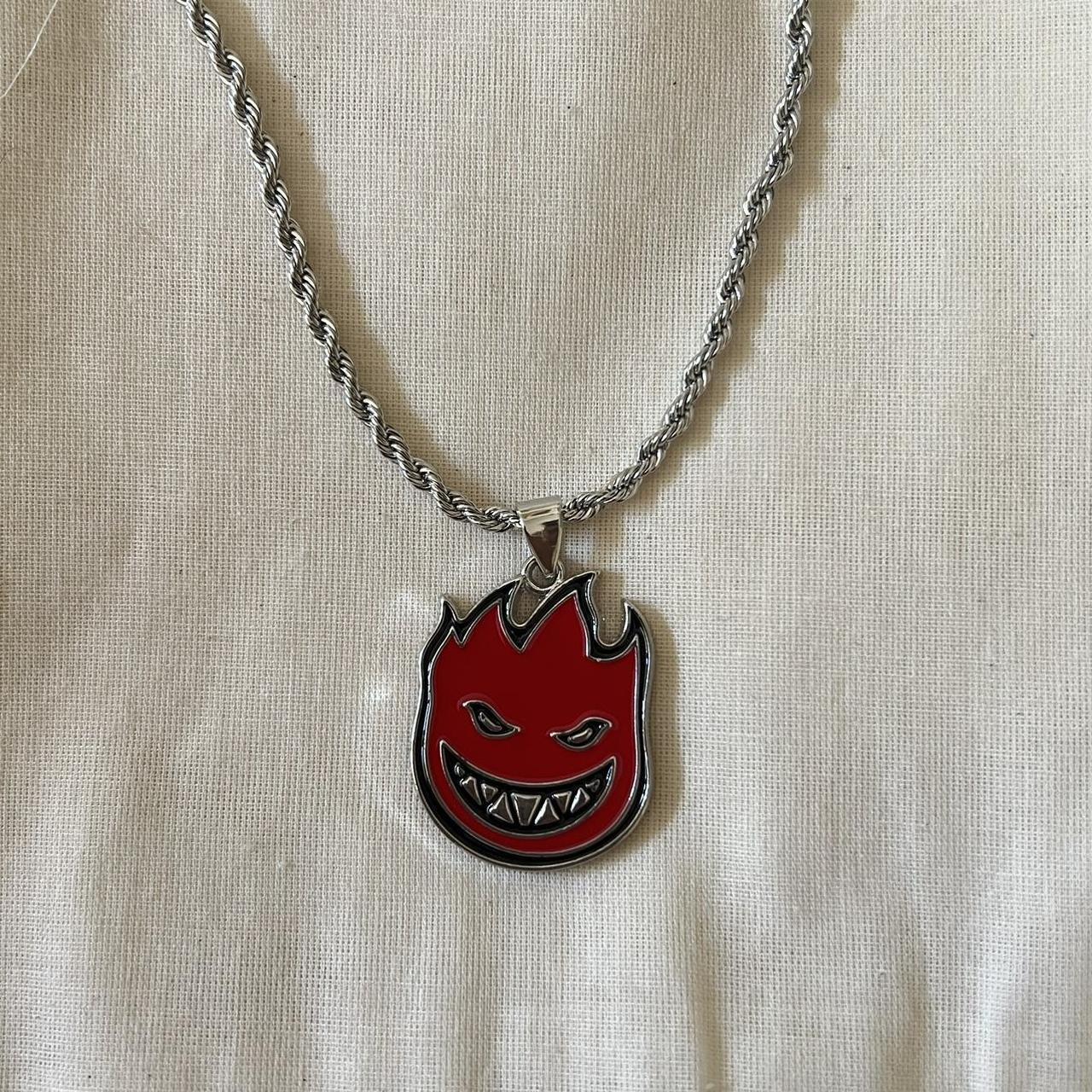 y2k style silver chrome spitfire skater pendant... | Depop