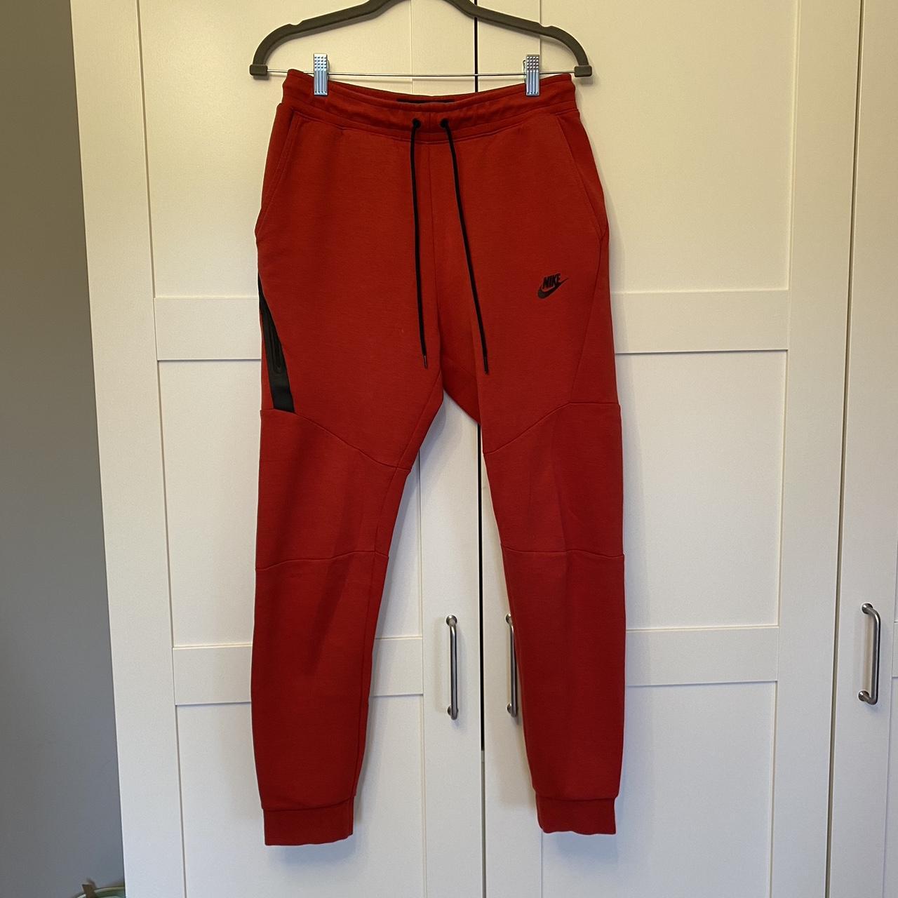 Men’s medium red Nike tech joggers, few marks and... - Depop
