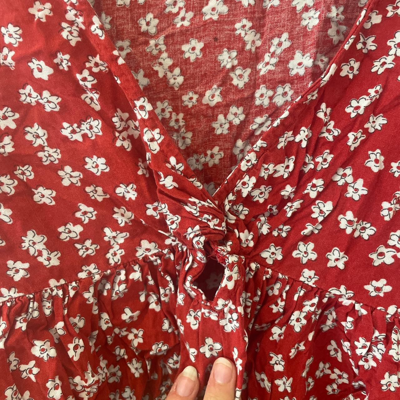 Cropped red floral top with twist cut out... - Depop