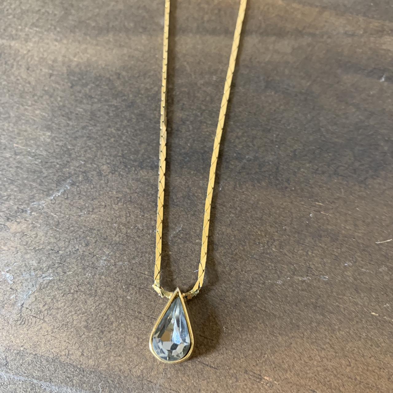 Vintage gold necklace with a light blue teardrop... - Depop