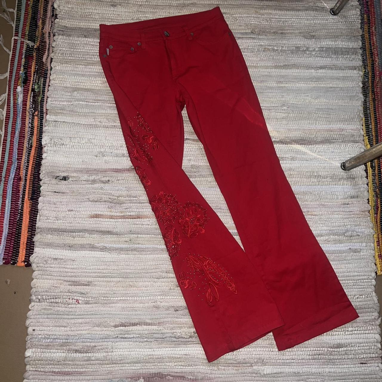 red flare pants one leg has designs and cut outs so... - Depop