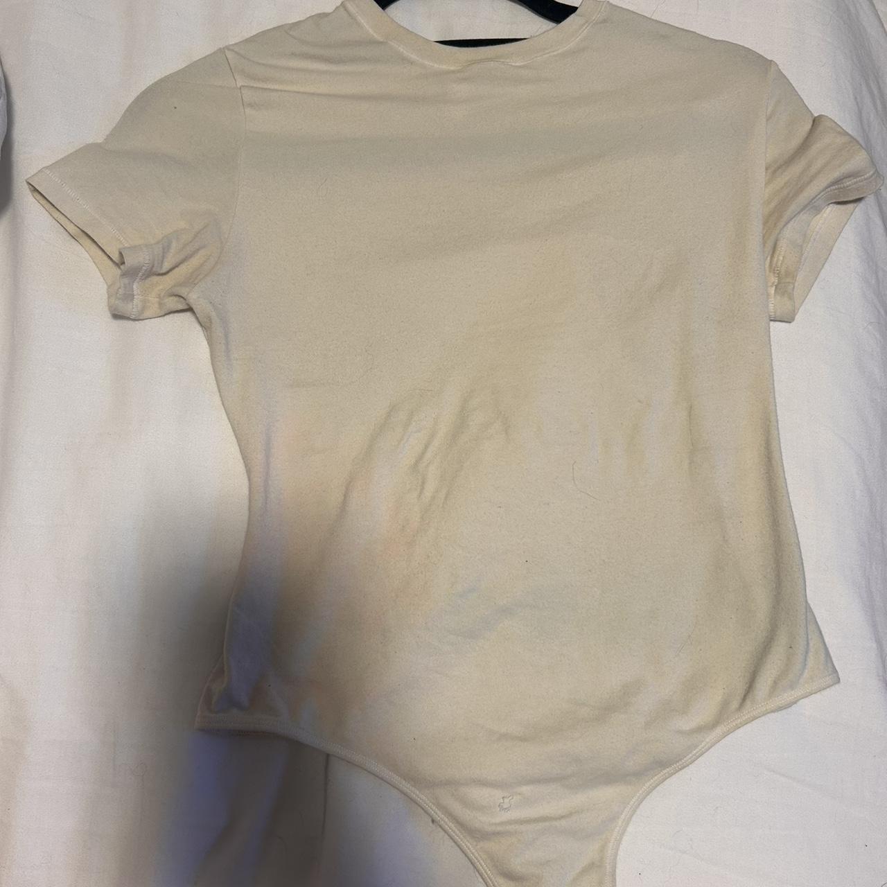 Skims cream T-shirt bodysuit Size M Pink stain on... - Depop