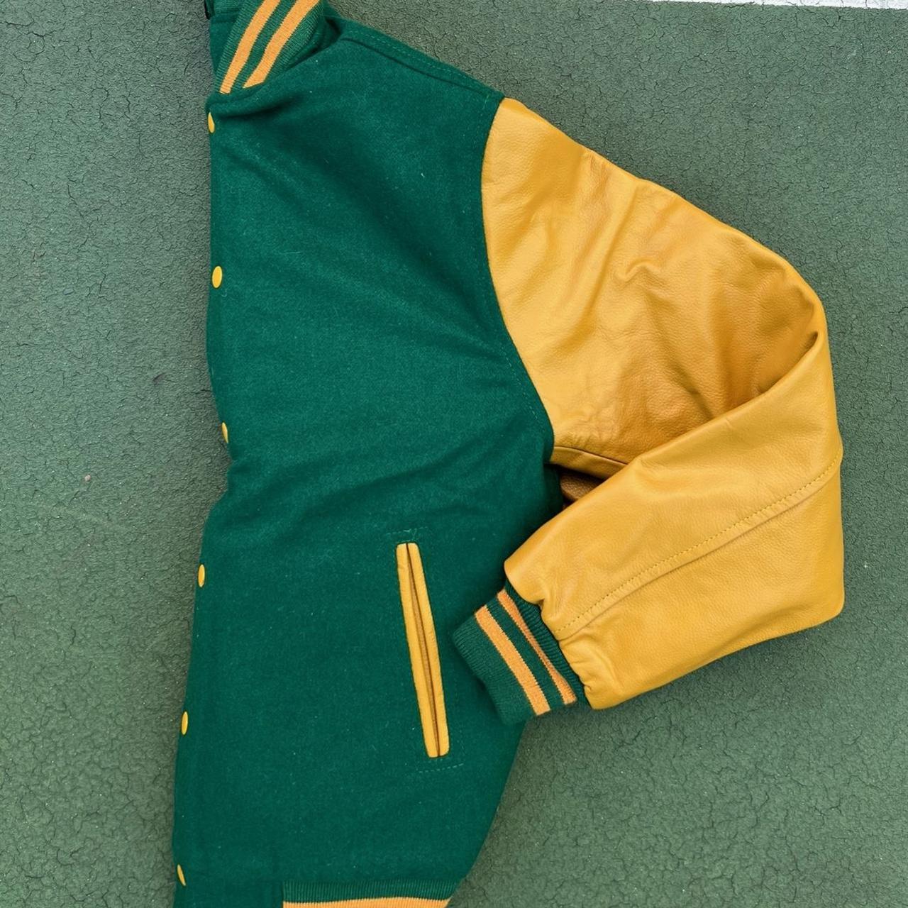 GREEN AND YELLOW VARSITY JACKET, WATERPROOF SIZE... - Depop