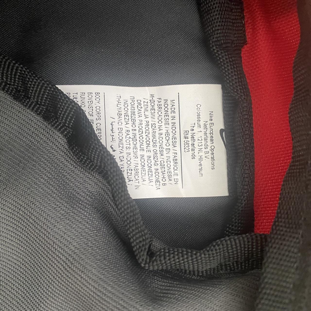 Red Nike backpack with white swoosh, couple light... - Depop