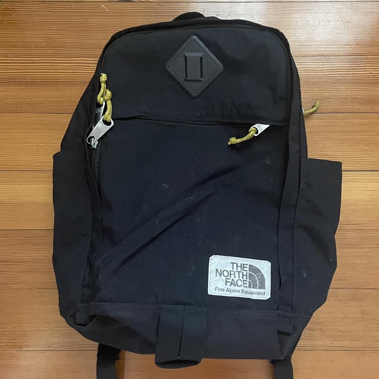 The North Face black backpack with yellow zipper... - Depop