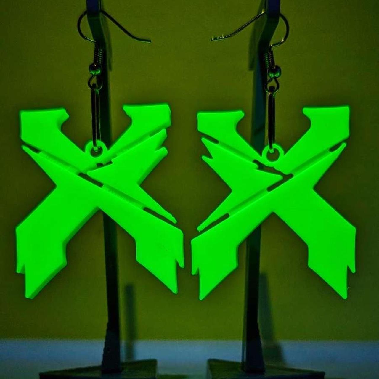 3D printed UV reactive green EXCISION earrings with... | Depop