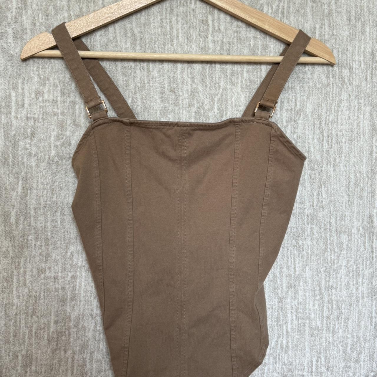 Brown H&M body suit with gold hardware. Size: s... - Depop