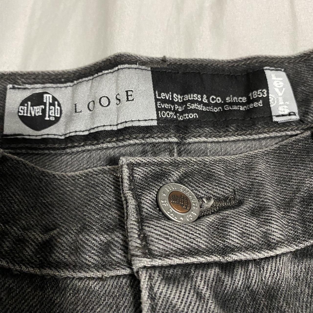 Black Levi’s loose sliver tab jeans -cut at the bottom | Depop