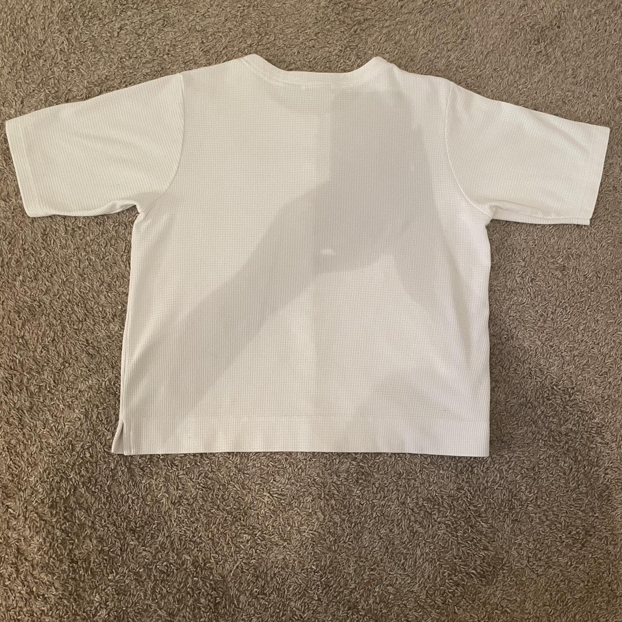 white shirt missing a button and has two small... - Depop