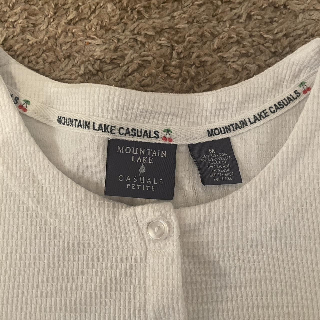 white shirt missing a button and has two small... - Depop