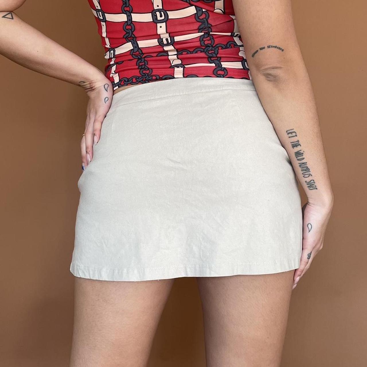 Cream mini skort with v waistline. In built shorts... - Depop