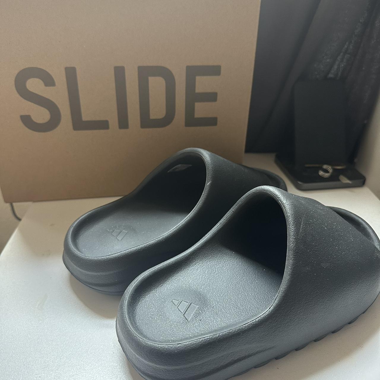 Authentic Yeezy slides in Onyx. Size 4 mens which is... - Depop