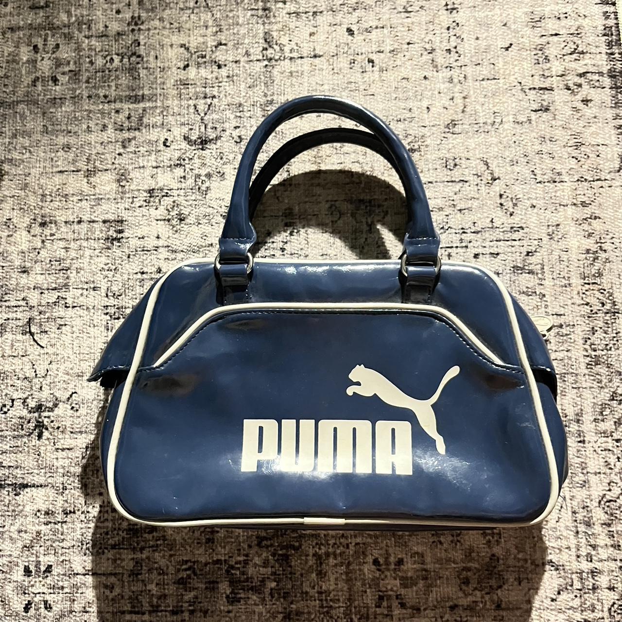 Puma navy and white mini purse Colour looks most. Depop