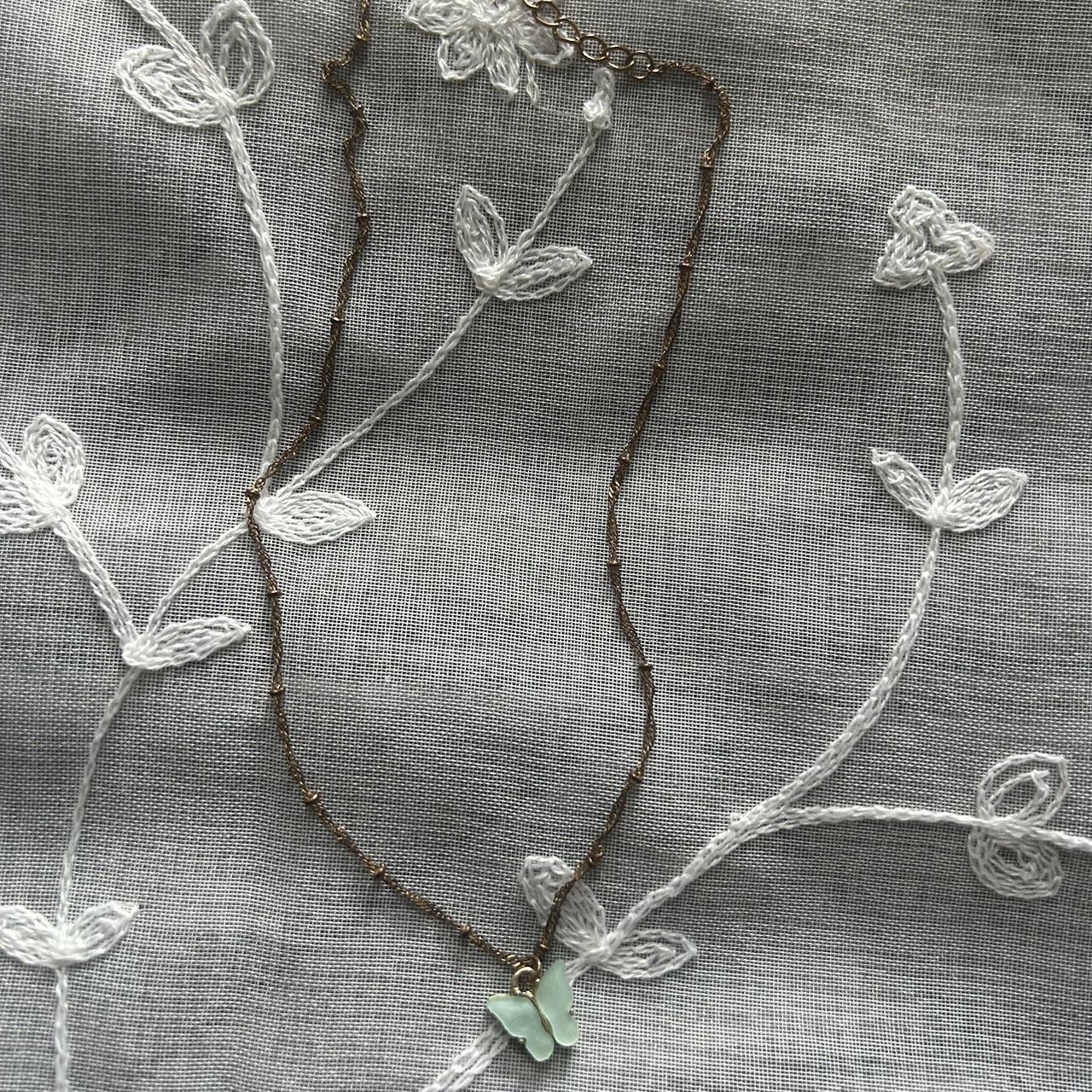 cute light green butterfly charm necklace! the chain... - Depop