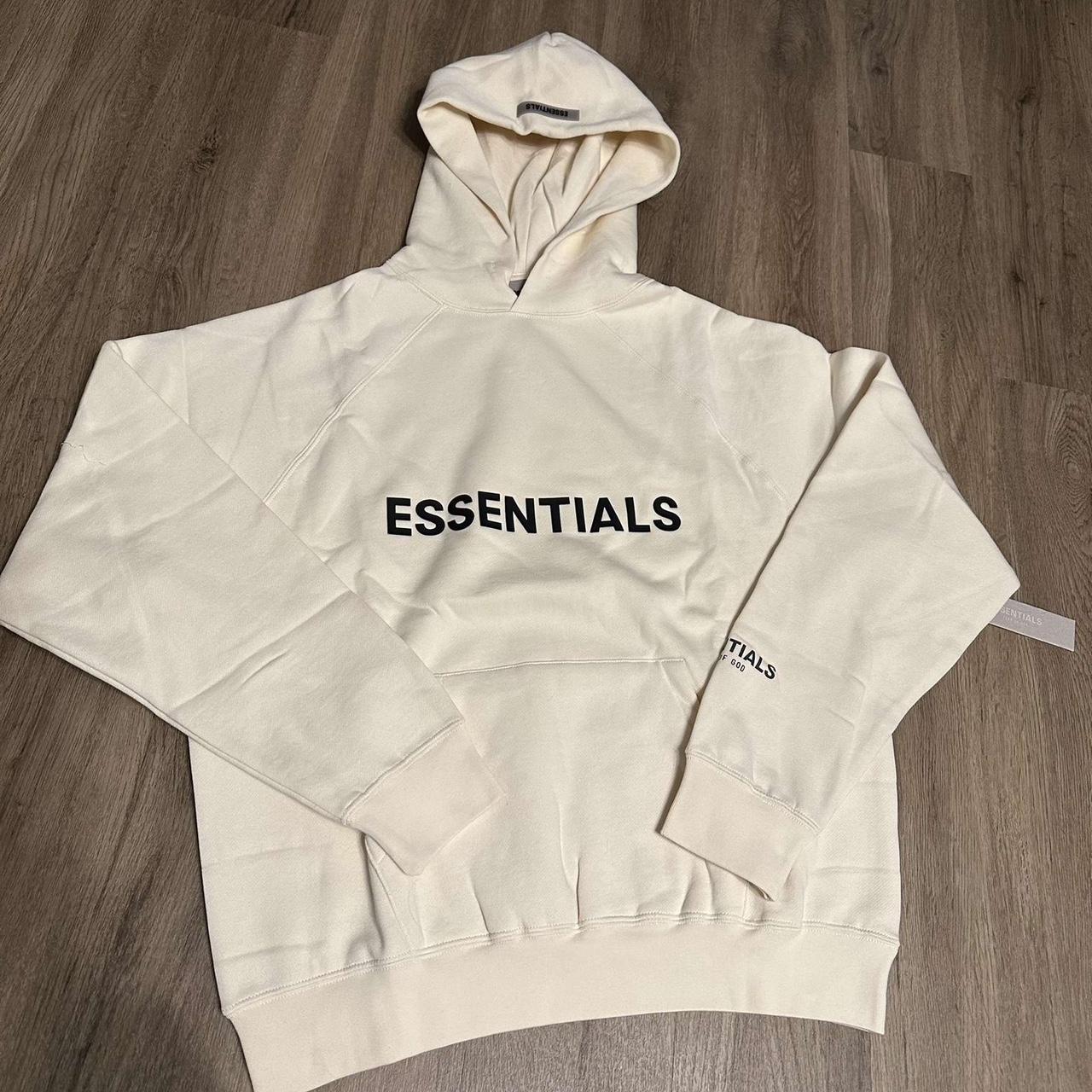 Essentials hoodie fear of god in cream with black... - Depop