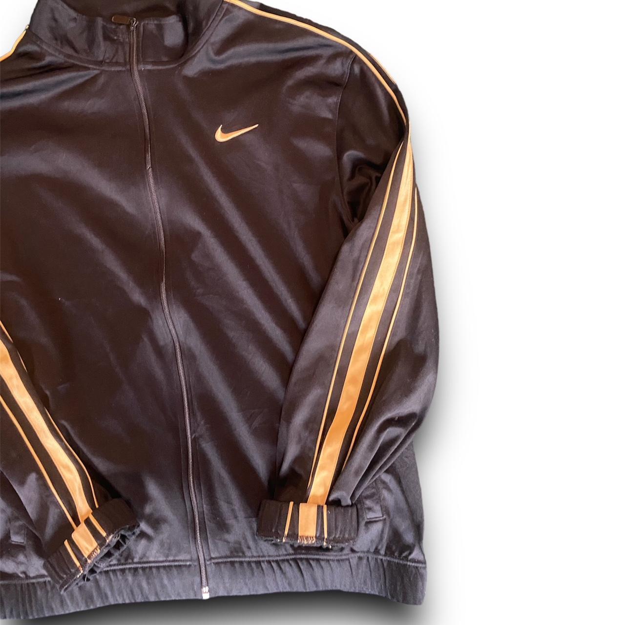 Perfect condition black and gold nike track jacket - Depop