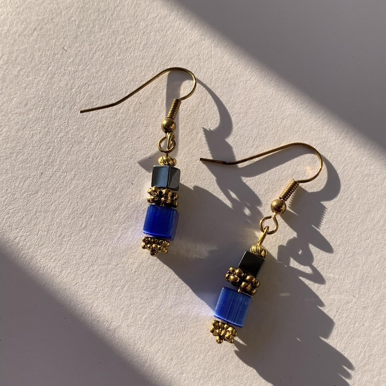 Blue and gold earrings, slight hook wear - Depop