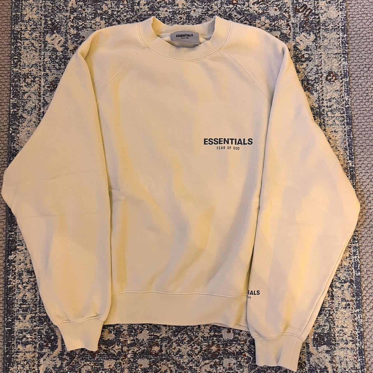 this is an essentials yellow sweatshirt that is in... - Depop