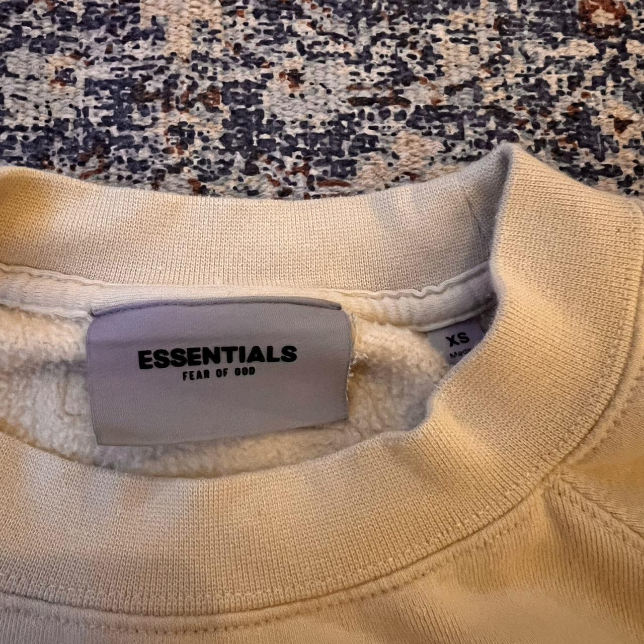 this is an essentials yellow sweatshirt that is in... - Depop