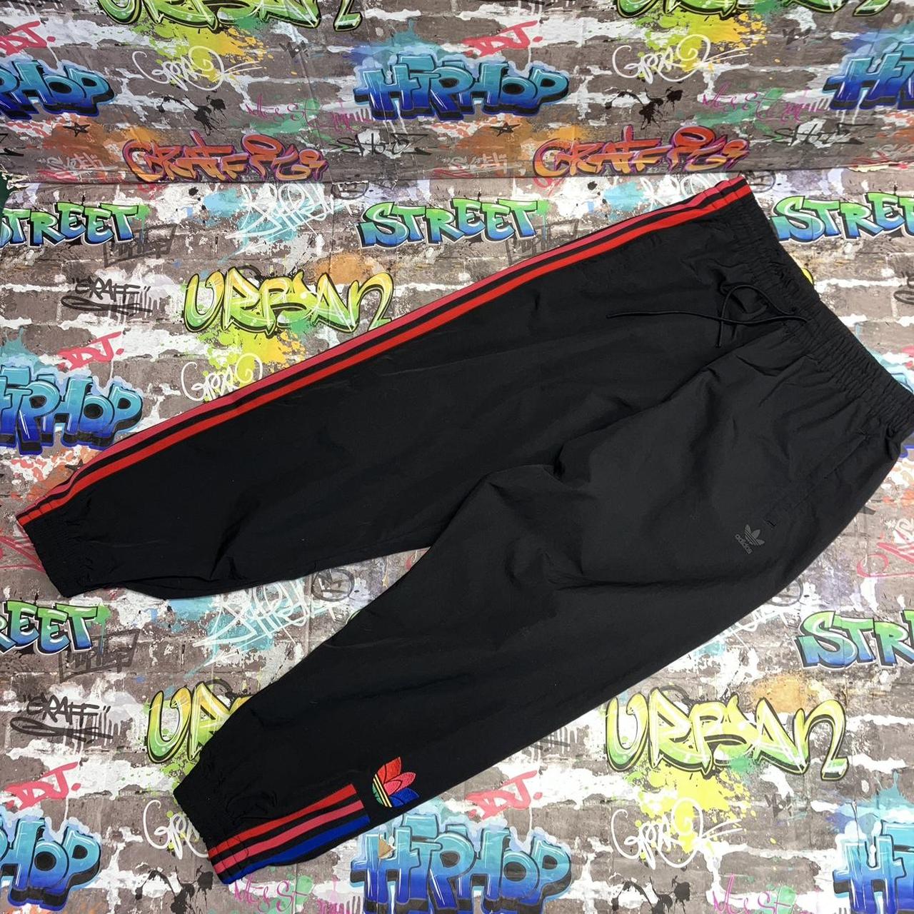 Adidas black shell style joggers with coloured... - Depop