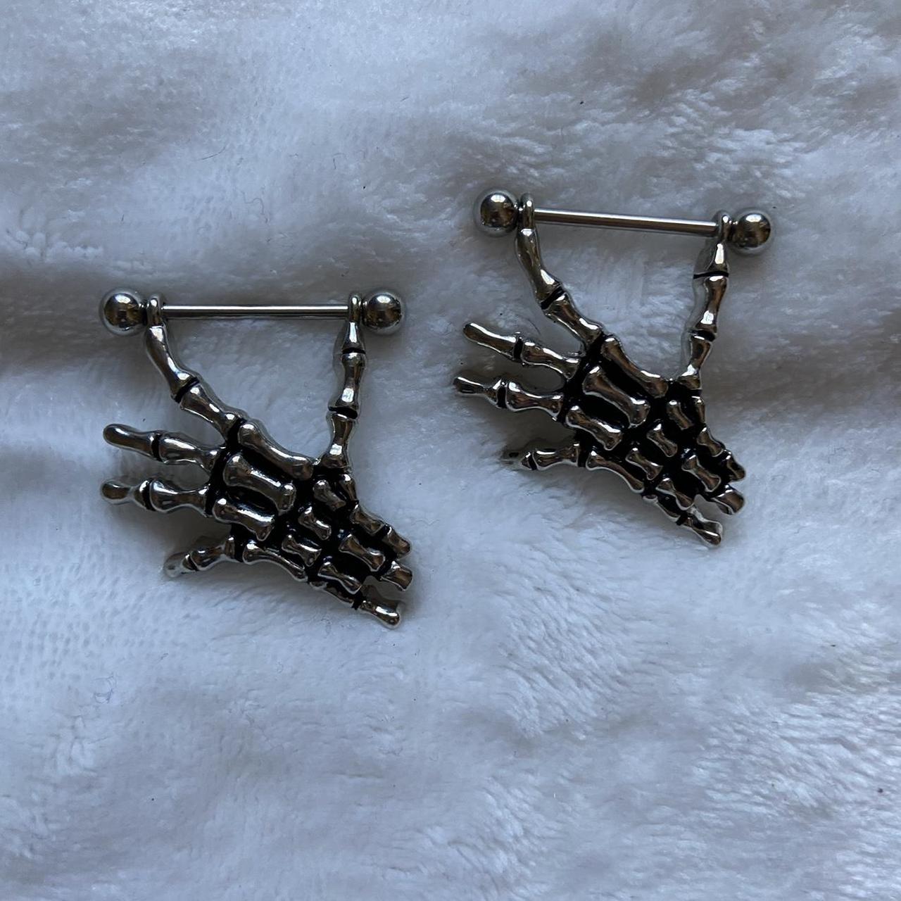 skeleton hand nipple piercings chrome/silver bought... - Depop