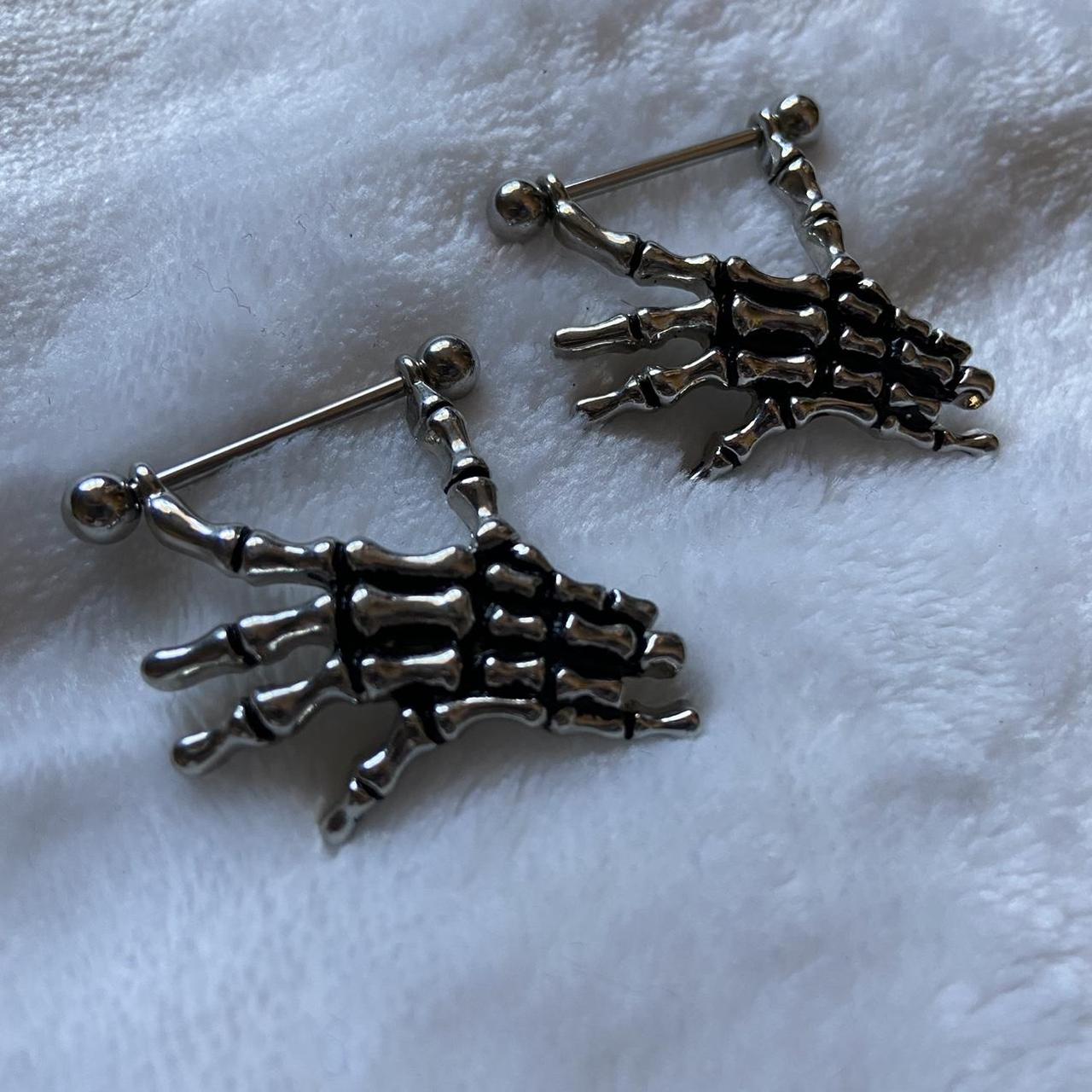 skeleton hand nipple piercings chrome/silver bought... - Depop