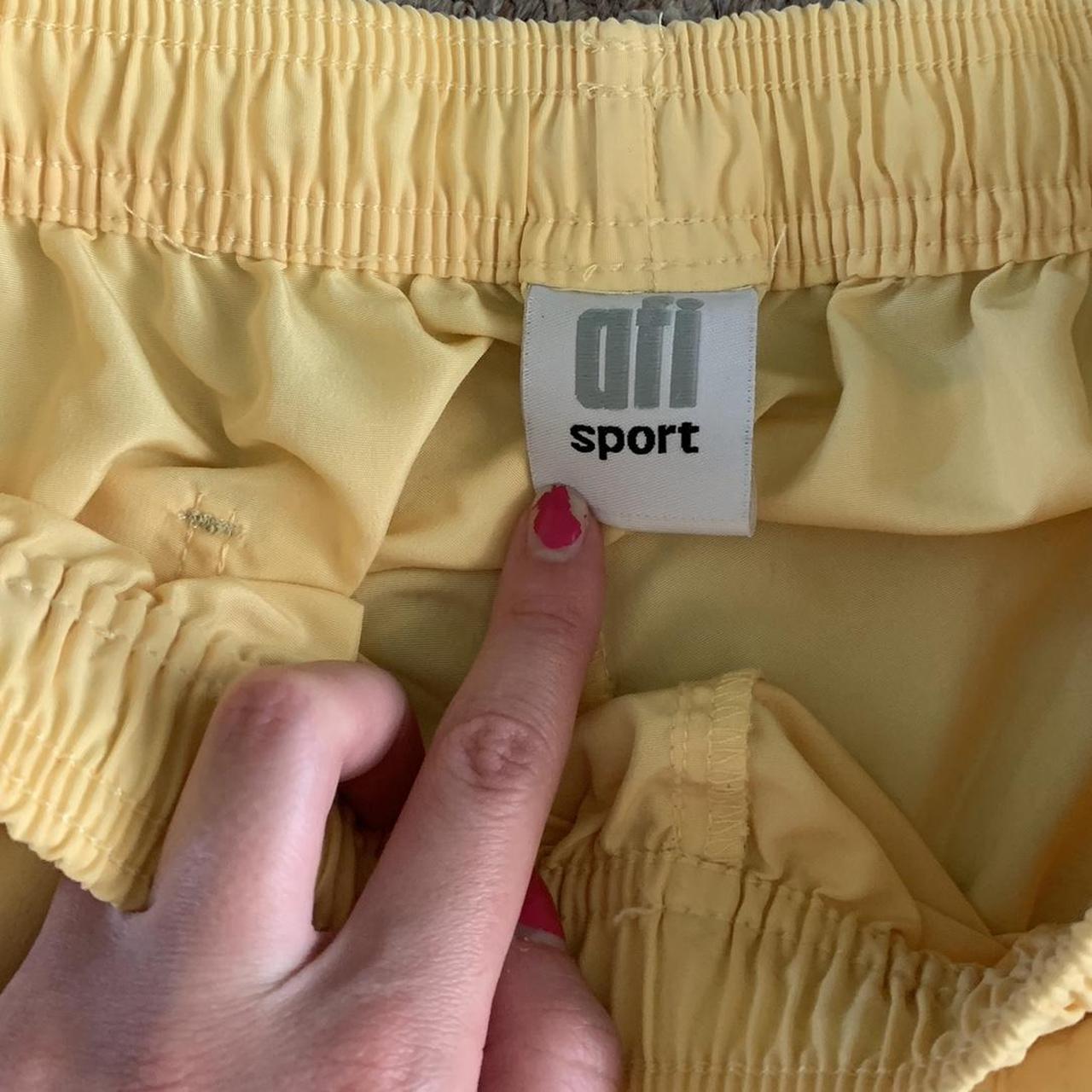 Yellow capri track pants. Super cute blue stripe... - Depop