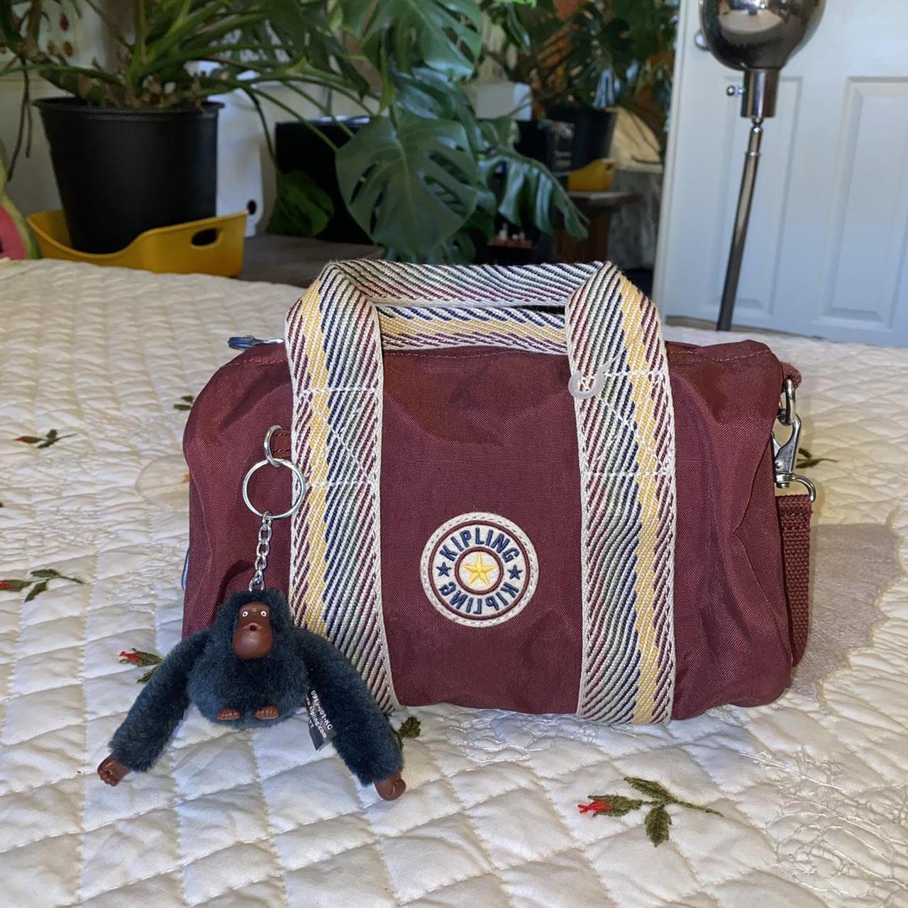 Burgundy Kipling Bag Has a cute little monkey... - Depop
