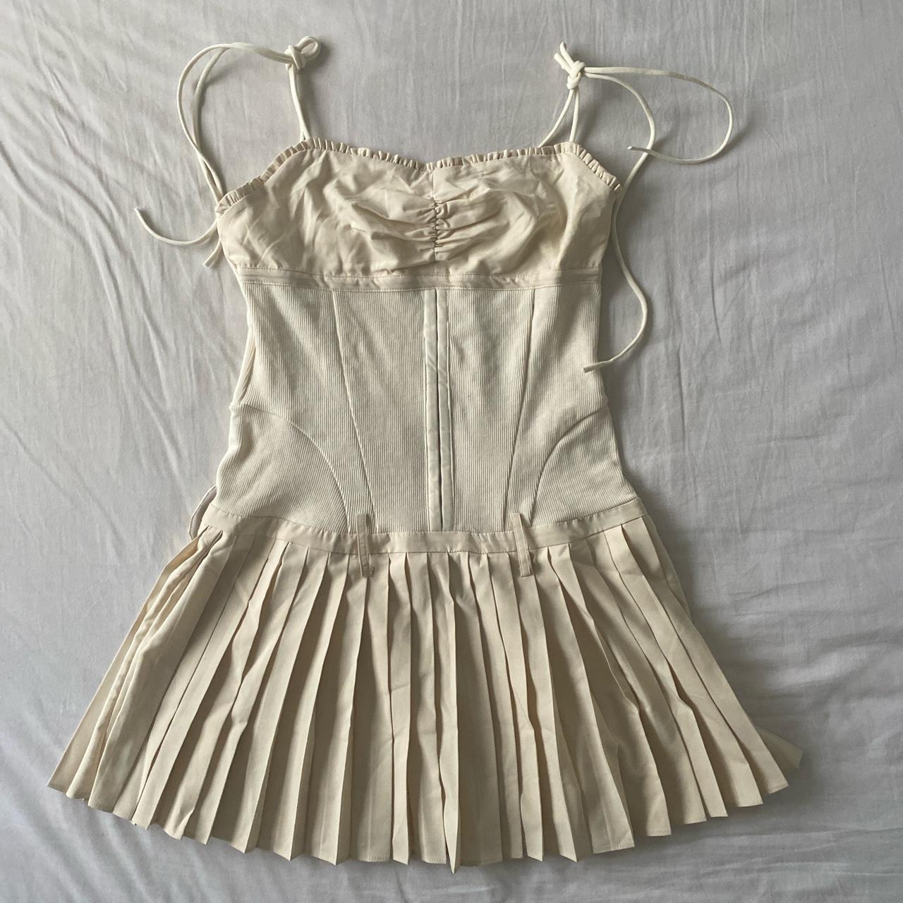 Yellow/Cream pleated mini dress with corset detail,... - Depop