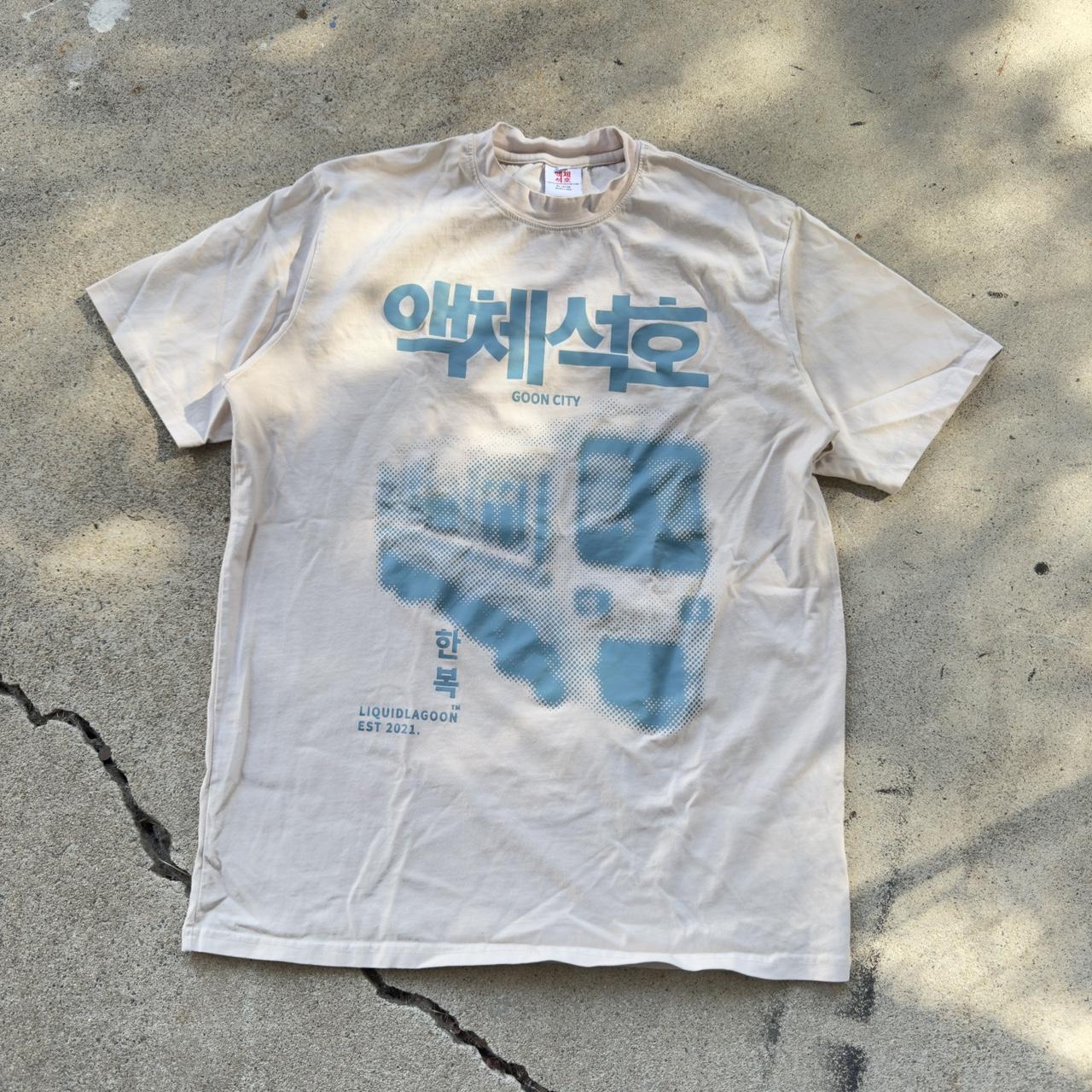 Liquid Lagoon Goon City Tee. Cream with blue print. - Depop