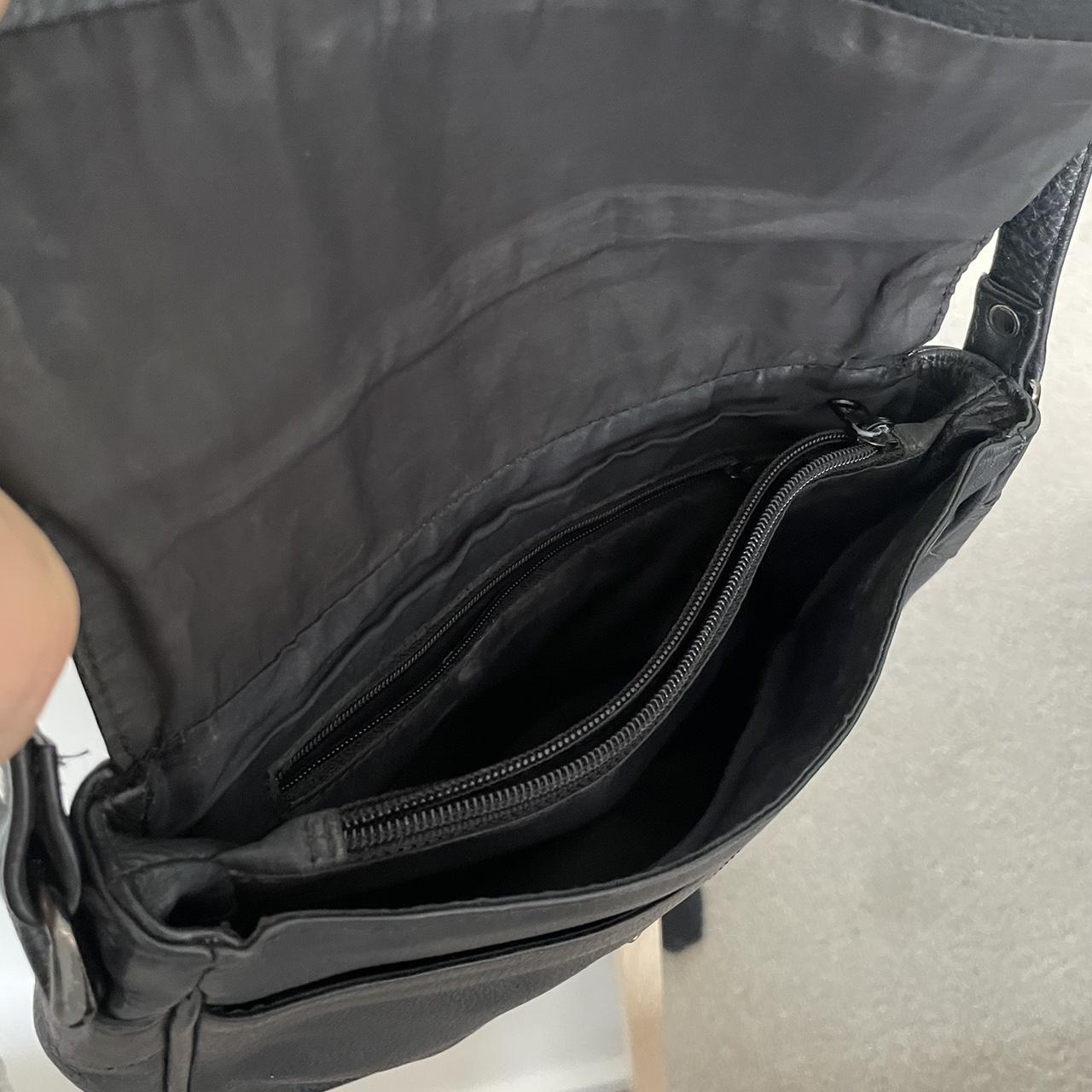 Black leather bag with a zipper closure and a... - Depop