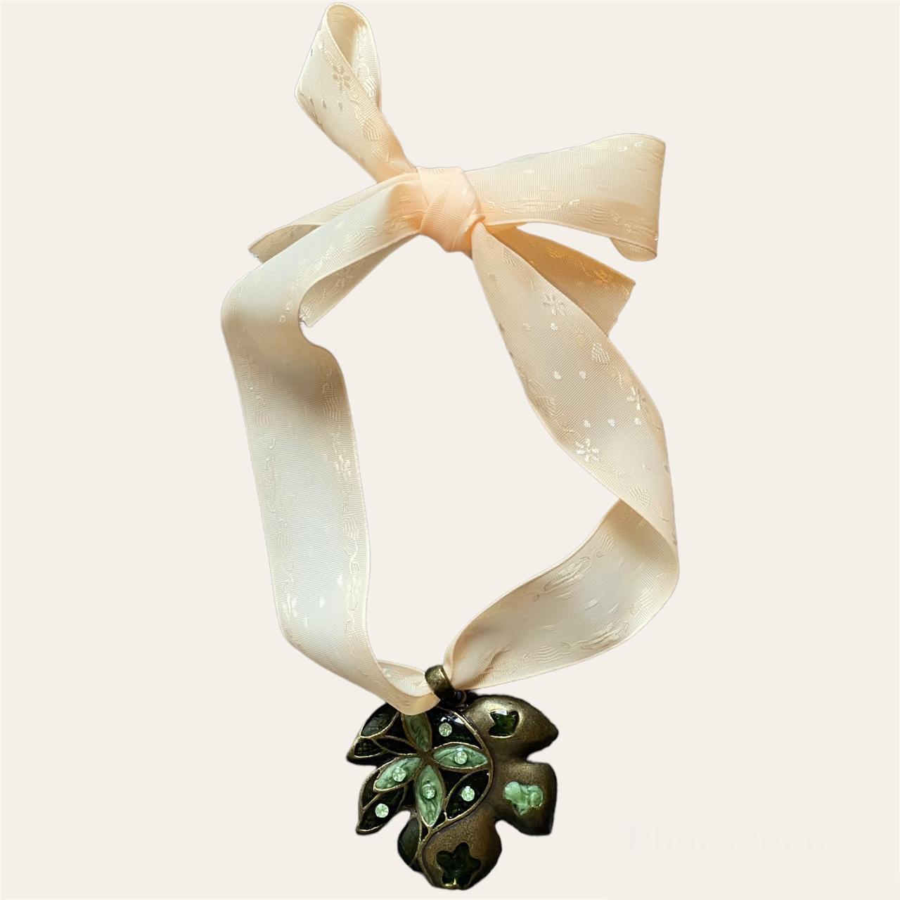 vintage brassy leaf pendant with cream ribbon... - Depop