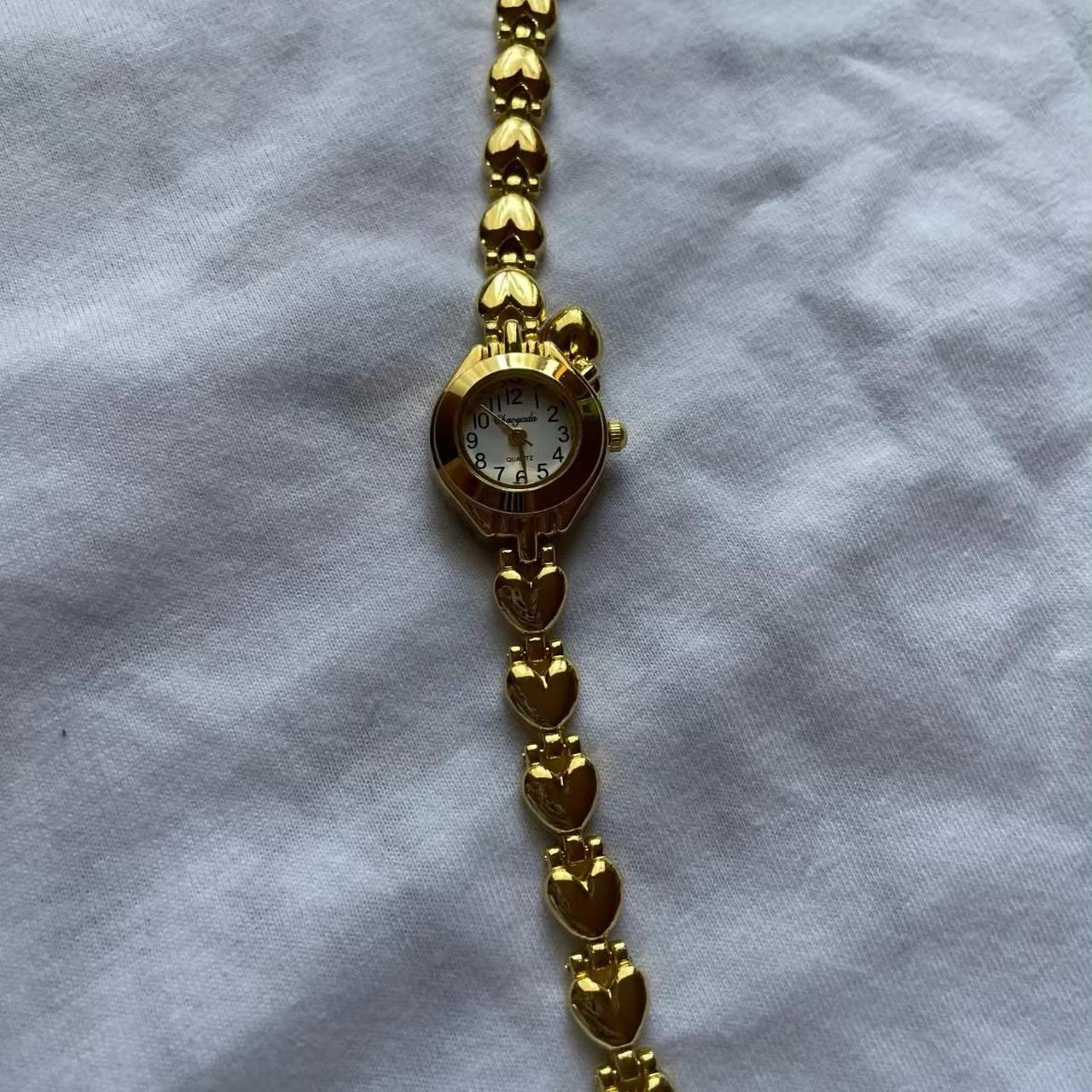 Gold tone heart shaped watch with a long band... - Depop