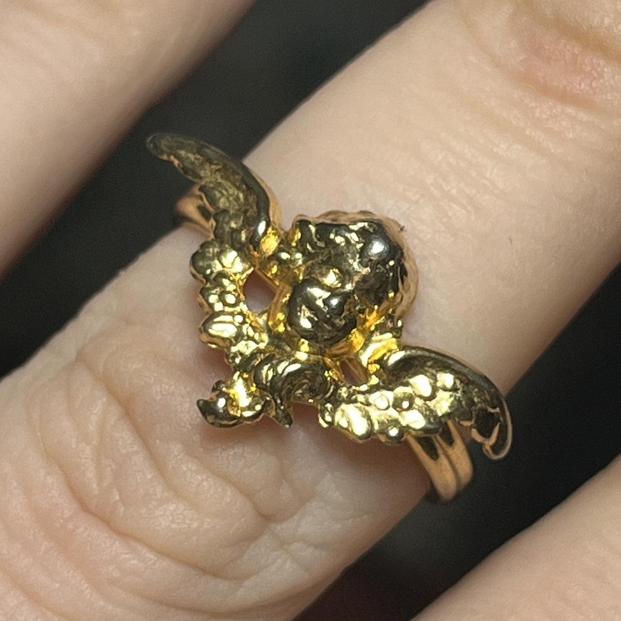 Gold angel ring with a touch of whimsy, featuring a... - Depop