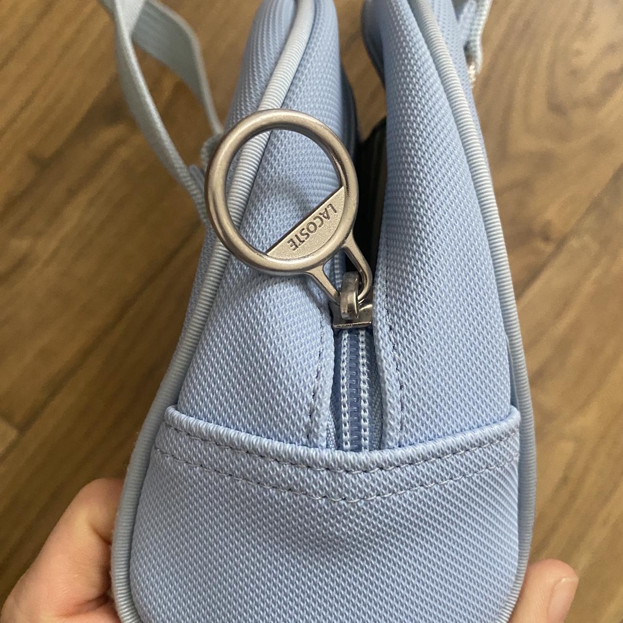 Lacoste light blue hand bag with striped interiors. - Depop