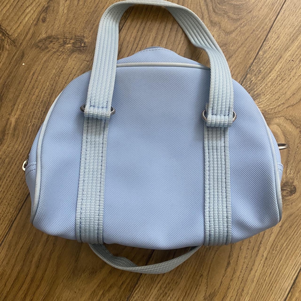 Lacoste light blue hand bag with striped interiors. - Depop