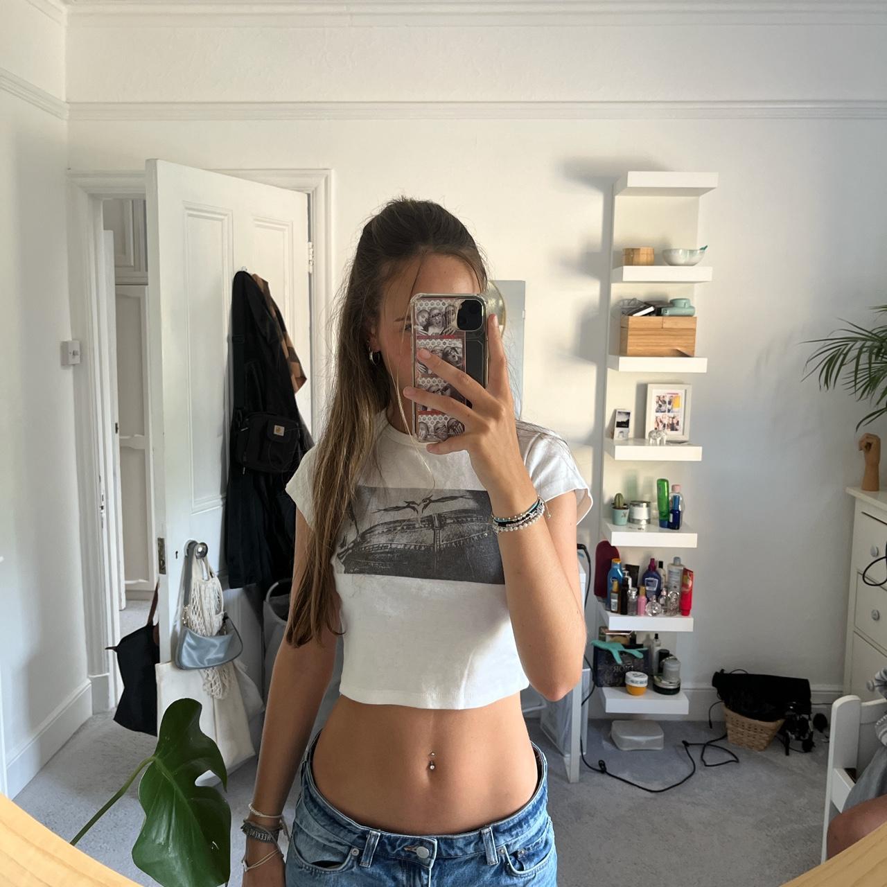 subdued white baby tee with cool graphic design... - Depop