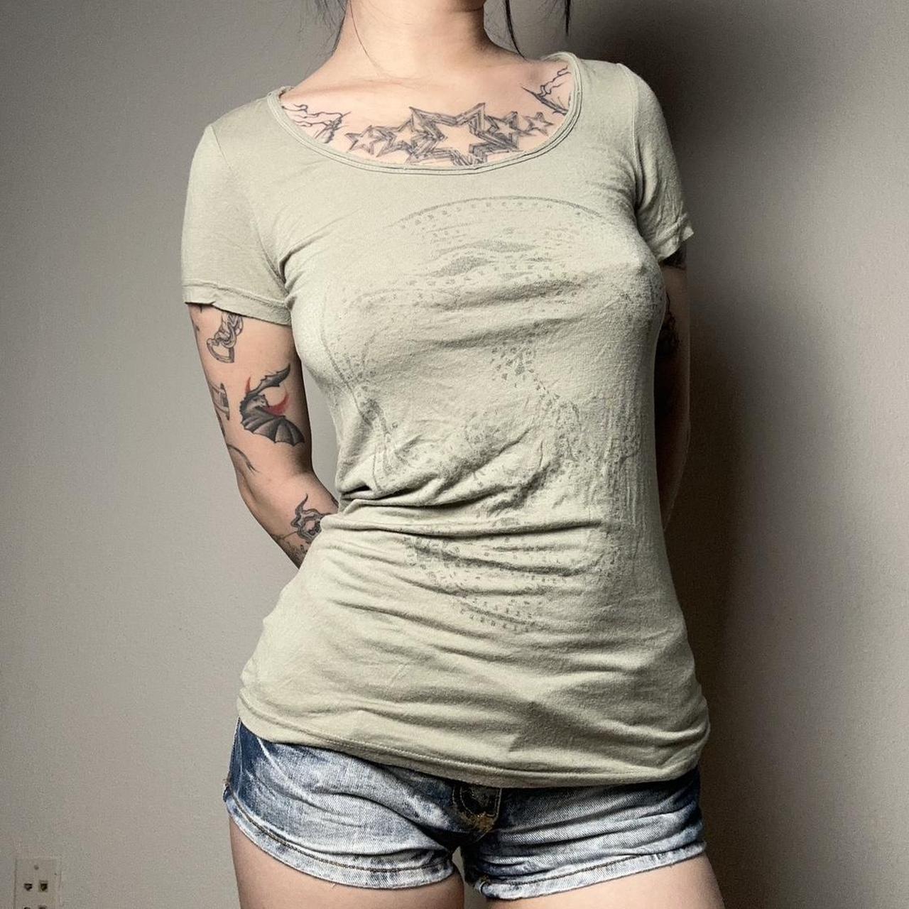 slashed back tee with skull print modeled on... - Depop