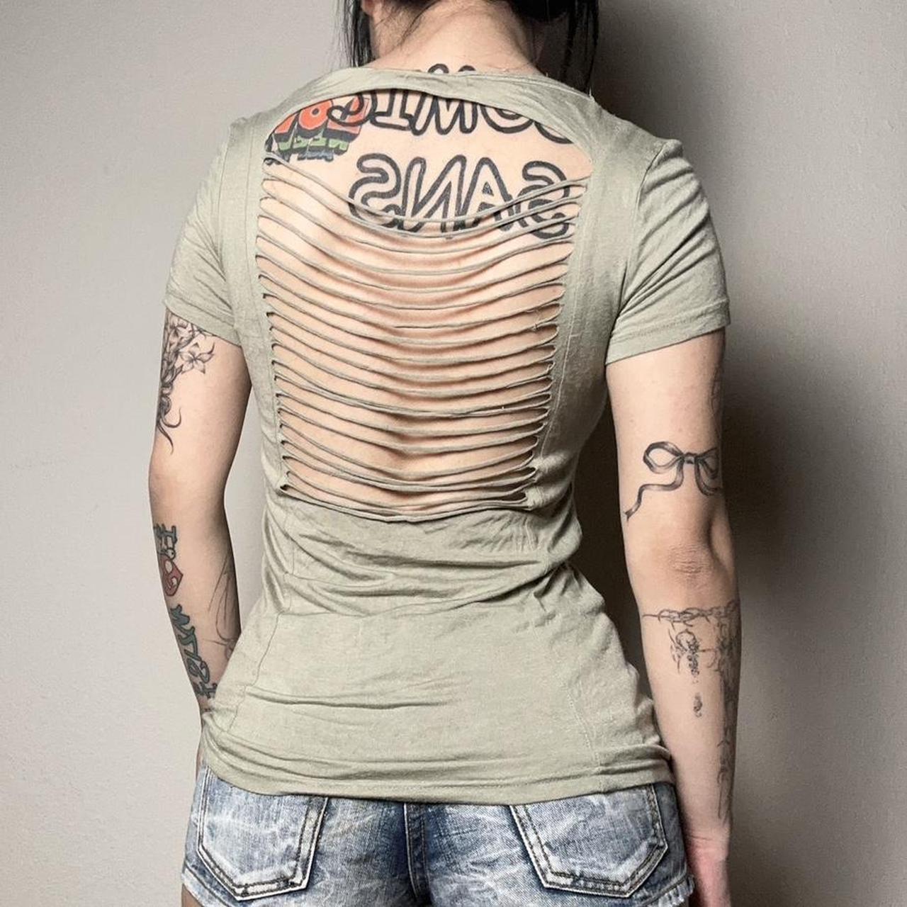 slashed back tee with skull print modeled on... - Depop