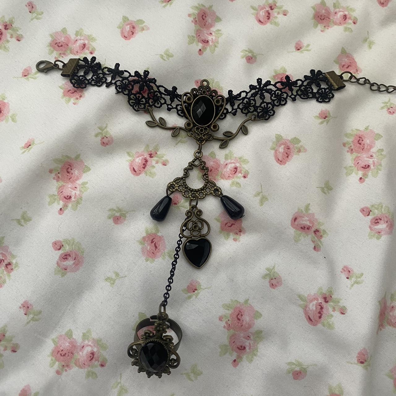 Gothic floral pattern bracelet with attached ring... - Depop