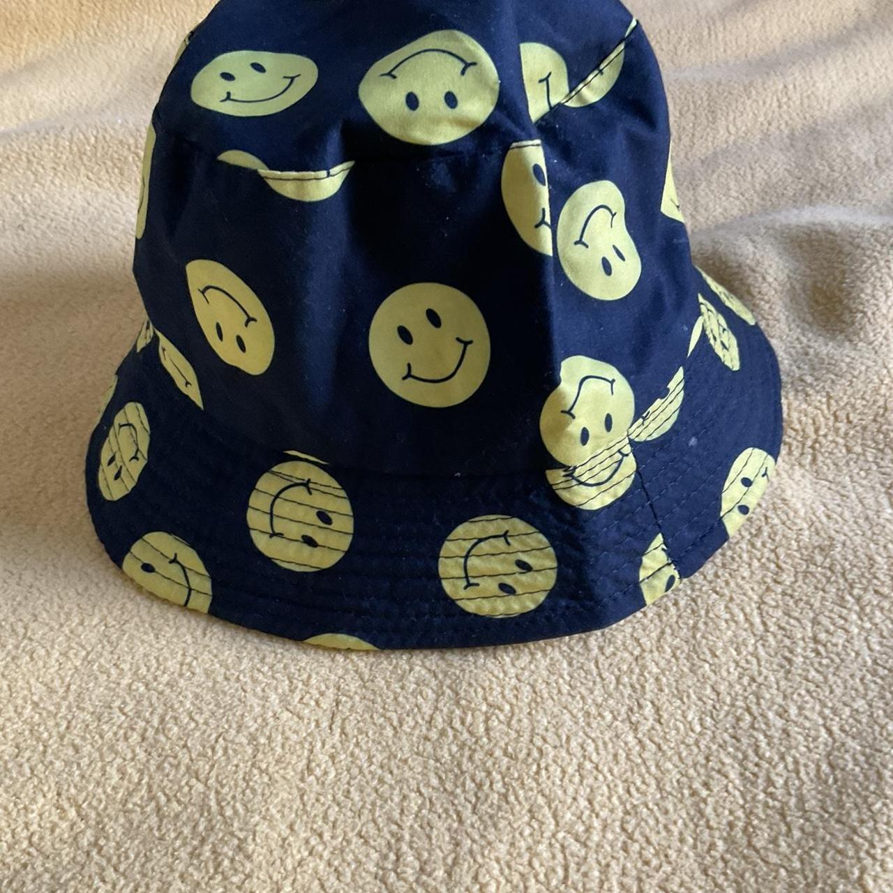 Smiley face bucket hat, shown on head circumference... - Depop