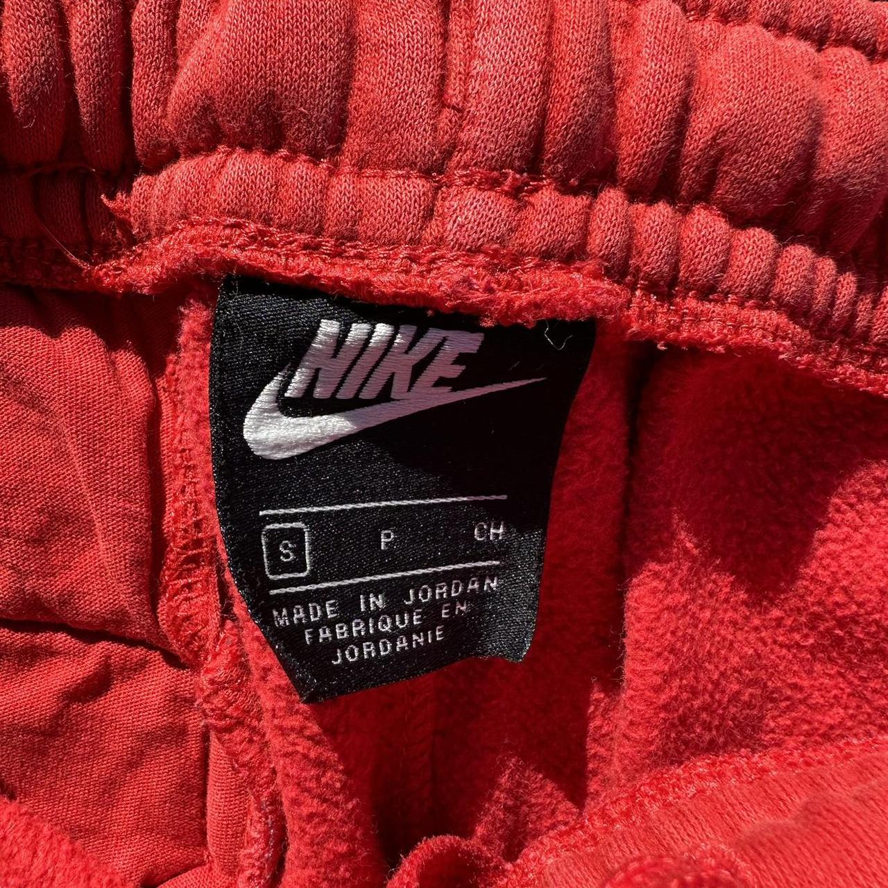 Red Nike sweatpants with white tick Size small - Depop