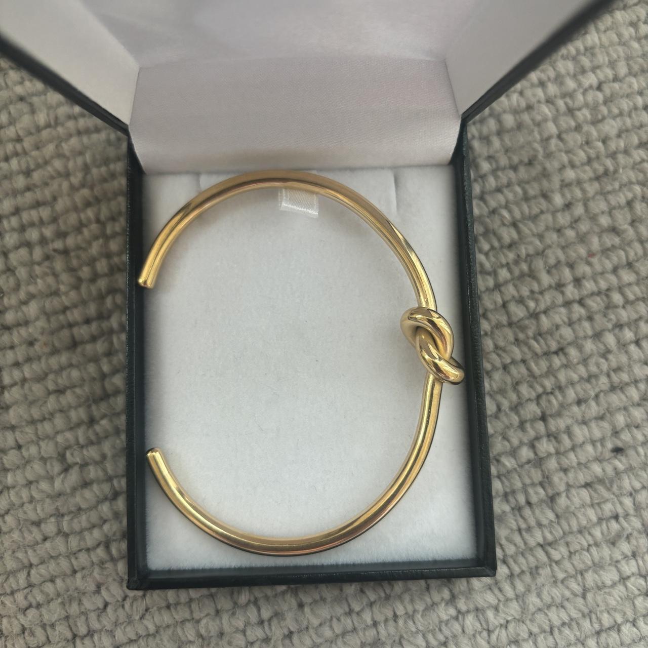 Beautiful brand new gold knot bangle resizable... - Depop