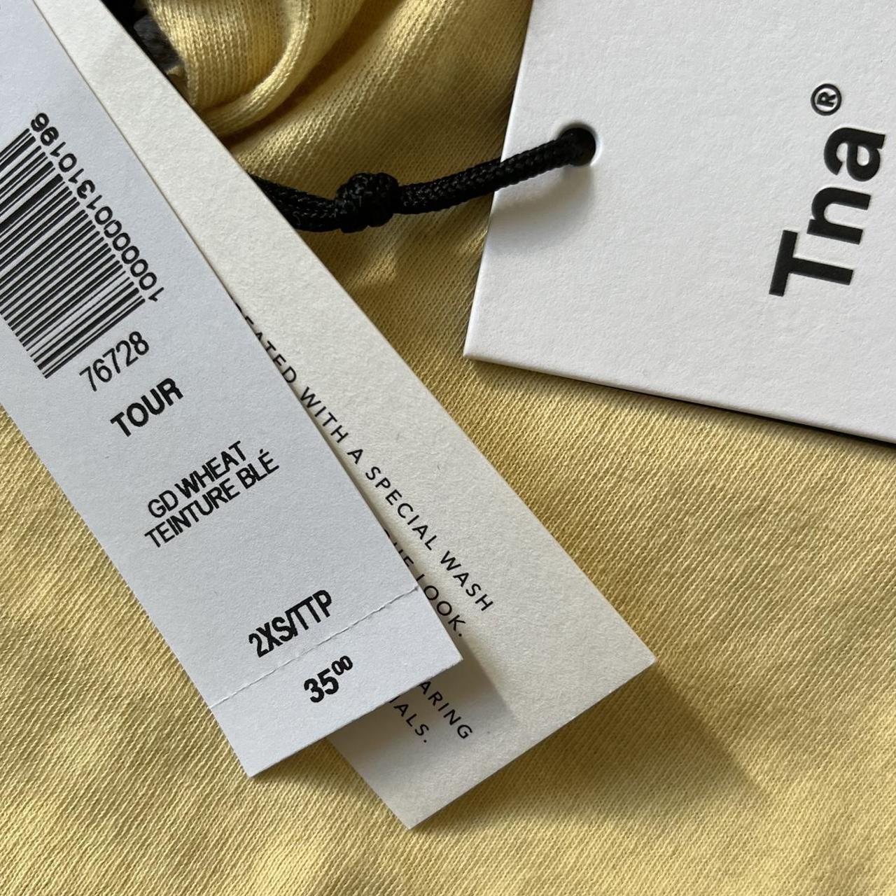 Aritzia yellow relaxed t-shirt - brand new with tags... - Depop