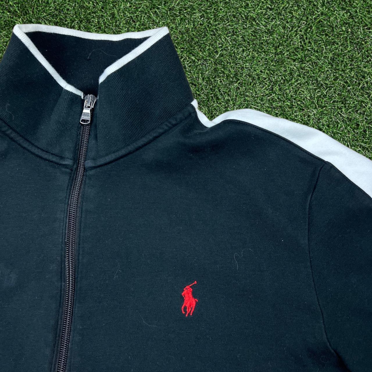 Black zip up polo jacket with red logo Size medium... - Depop