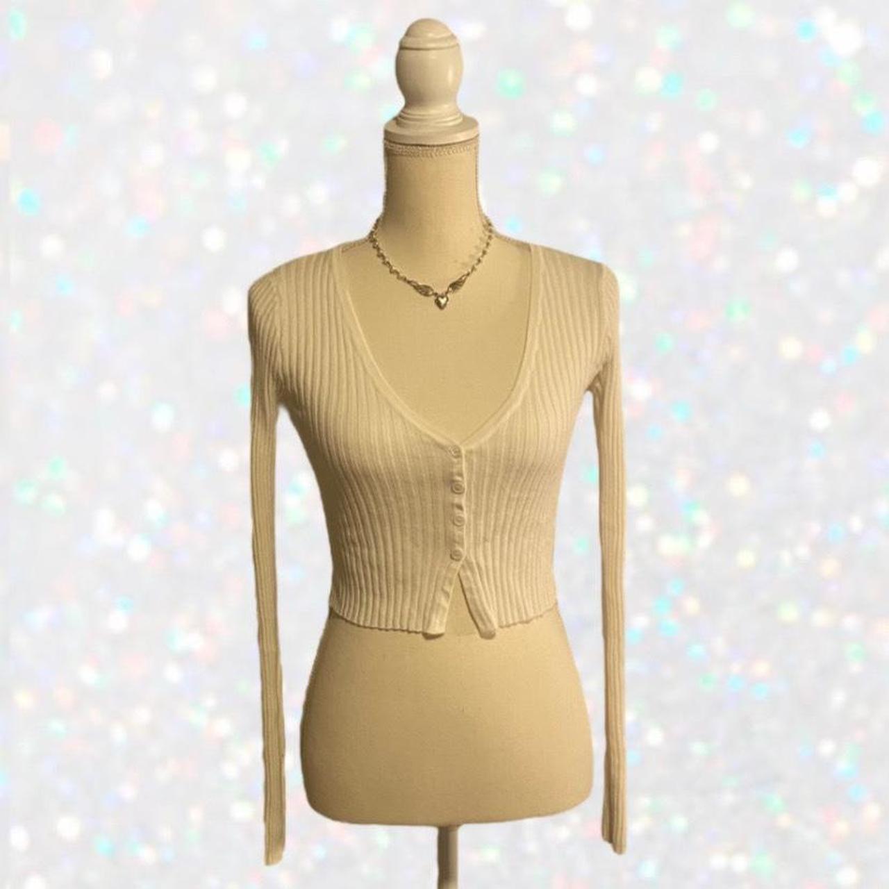 The stretchy knit four-button cropped long sleeve... - Depop