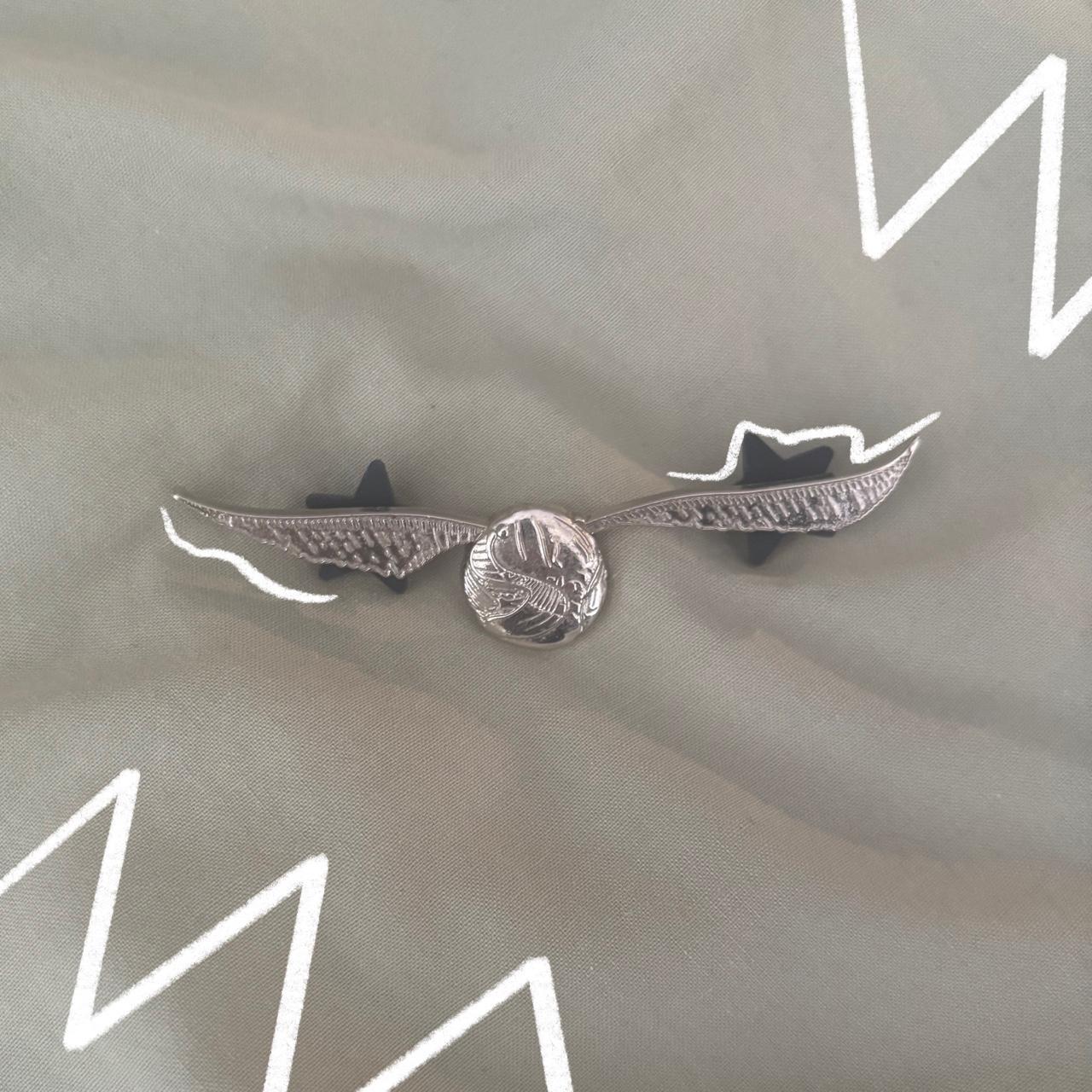 Silver Harry Potter pin featuring the Golden Snitch... - Depop