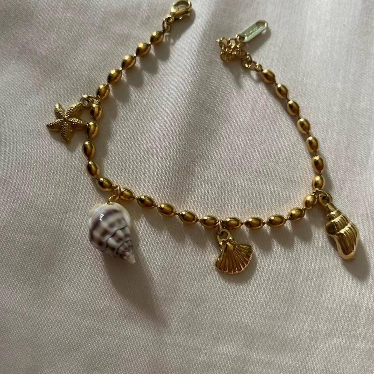 Gold shell bracelet with starfish, shell, and... | Depop