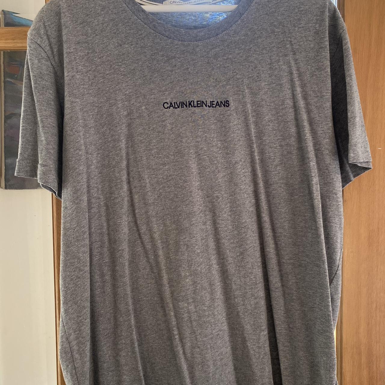 Grey Calvin Klein mid logo t shirt Short sleeved... - Depop