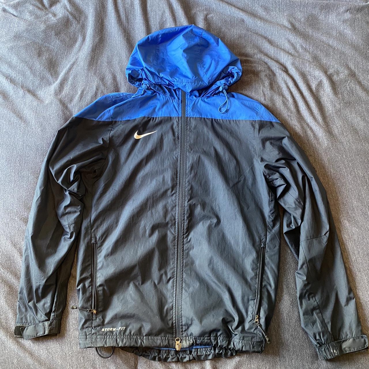 Blue Nike storm fit raincoat, labelled a size small... - Depop